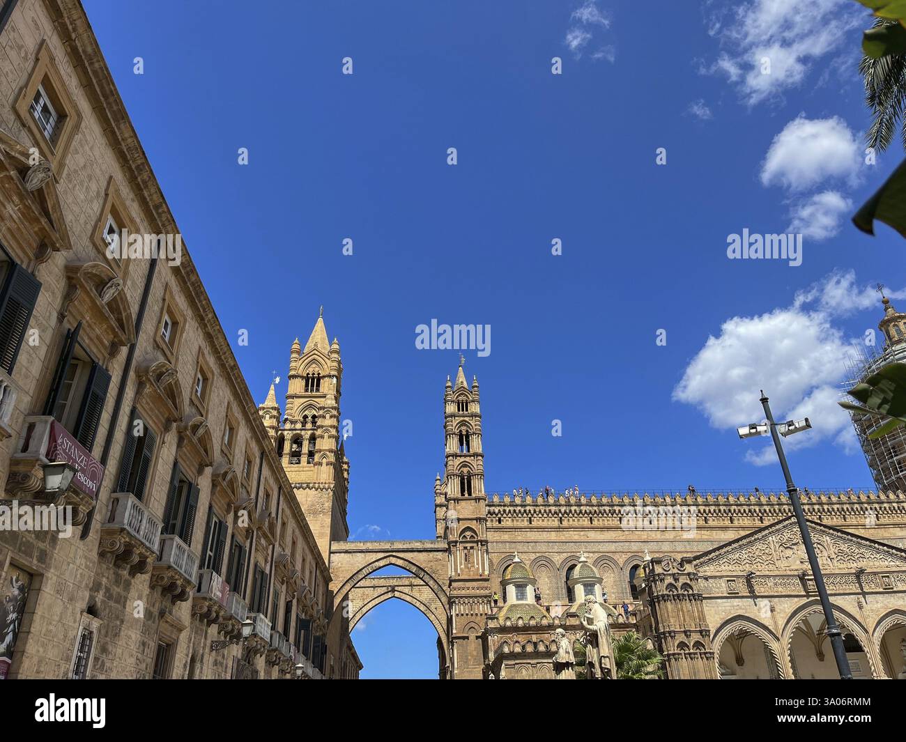 Sublime cathedral with high towers and stone arches under a blue sky ...