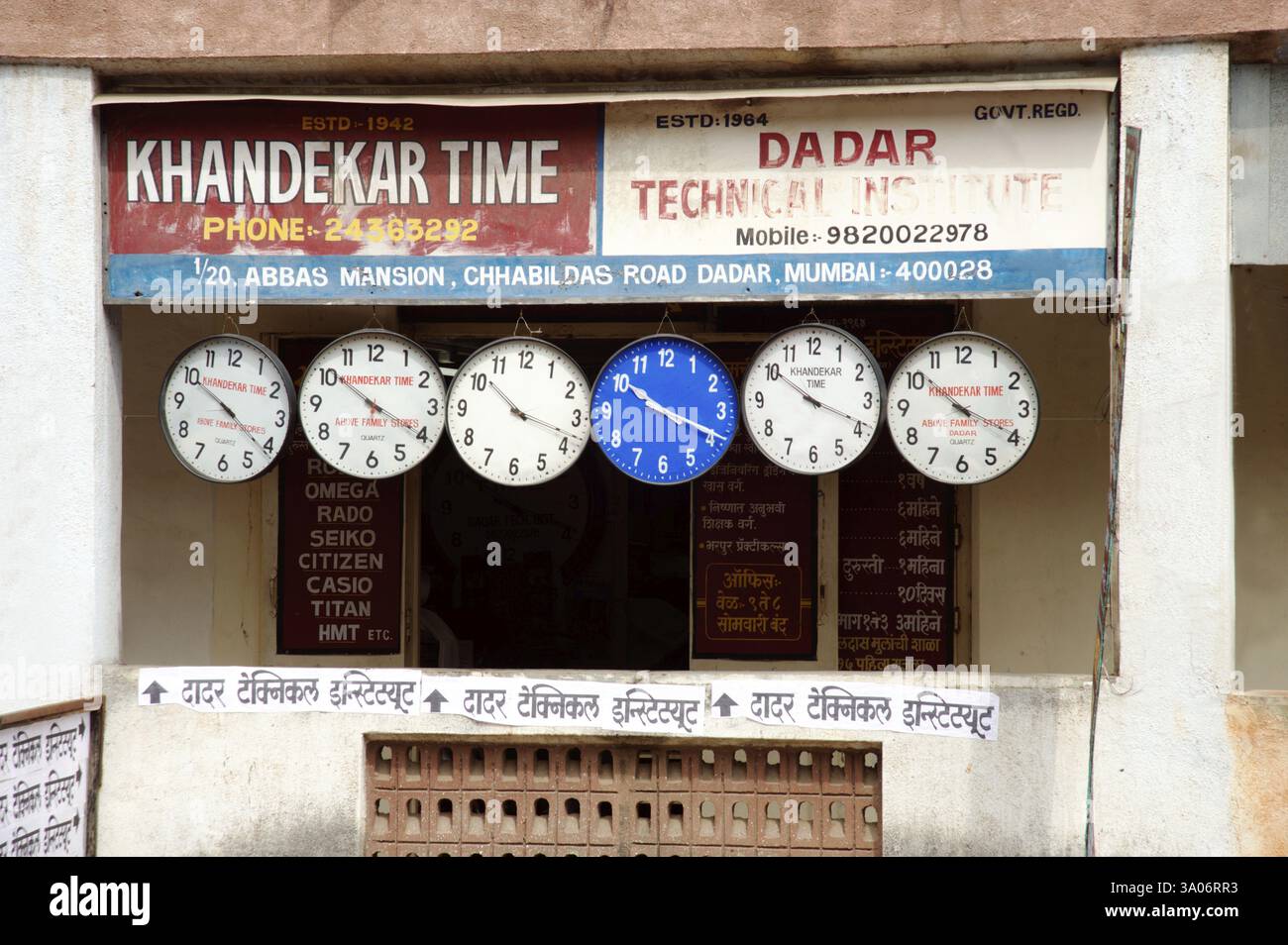 Time Wall Clock Hanging Outside of Shop Stock Photo - Alamy