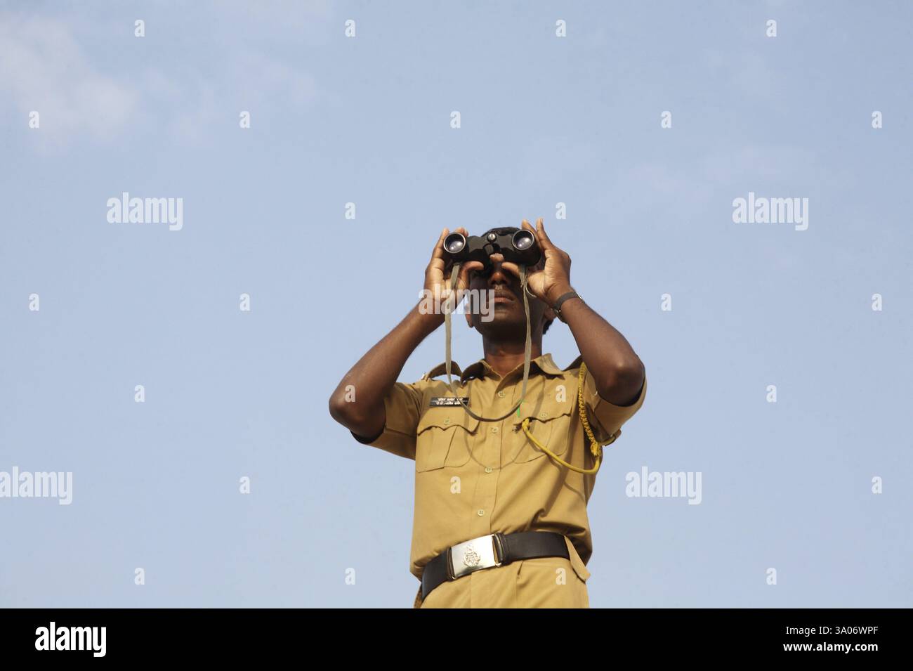 A policeman keeping a watch over the Eid al Fitr or Ramzan id namaaz at ...