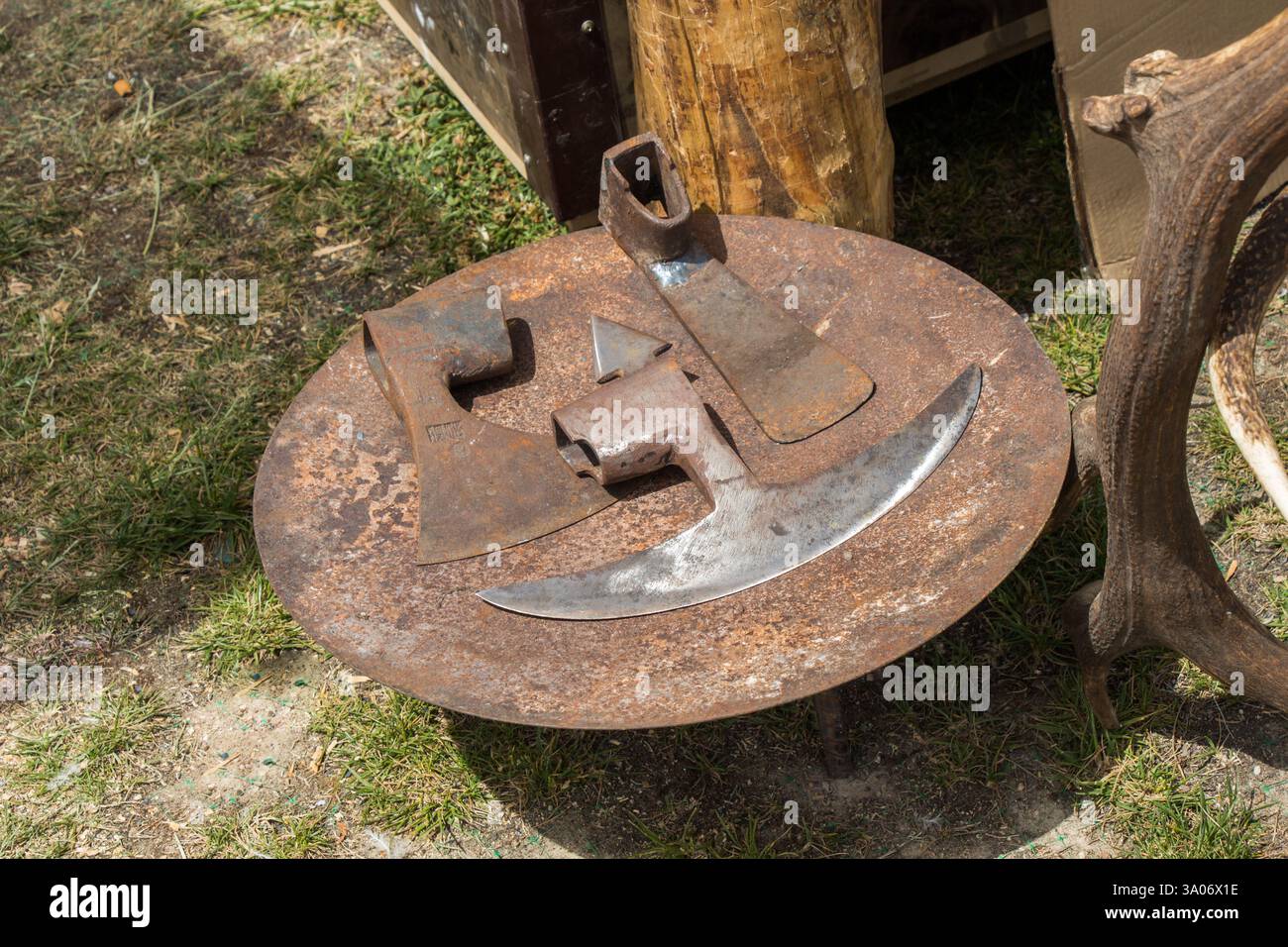 3 rusty steel axe heads in the view Stock Photo - Alamy