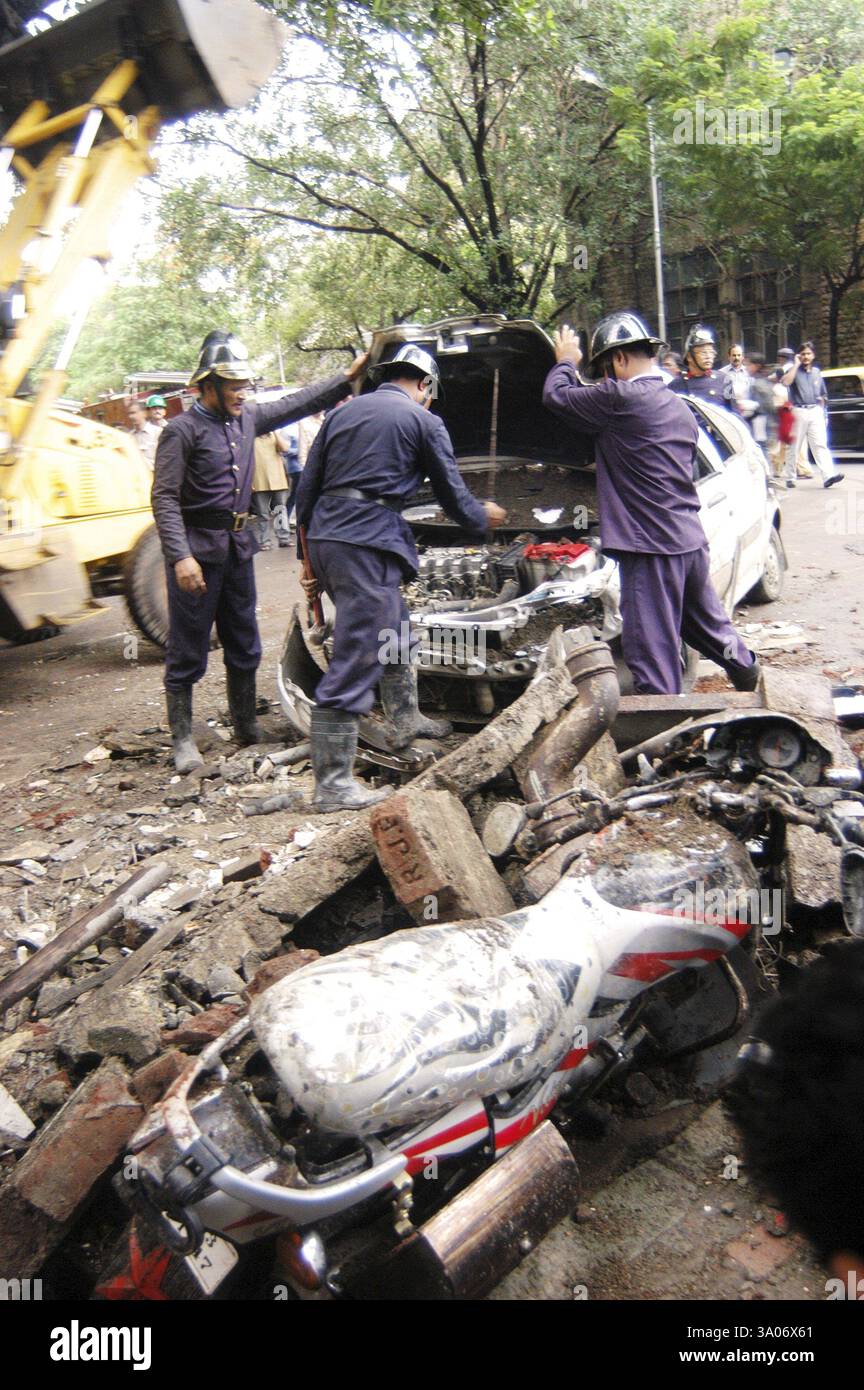 Fire brigade officers clear concrete debris fallen on vehicle part of ...