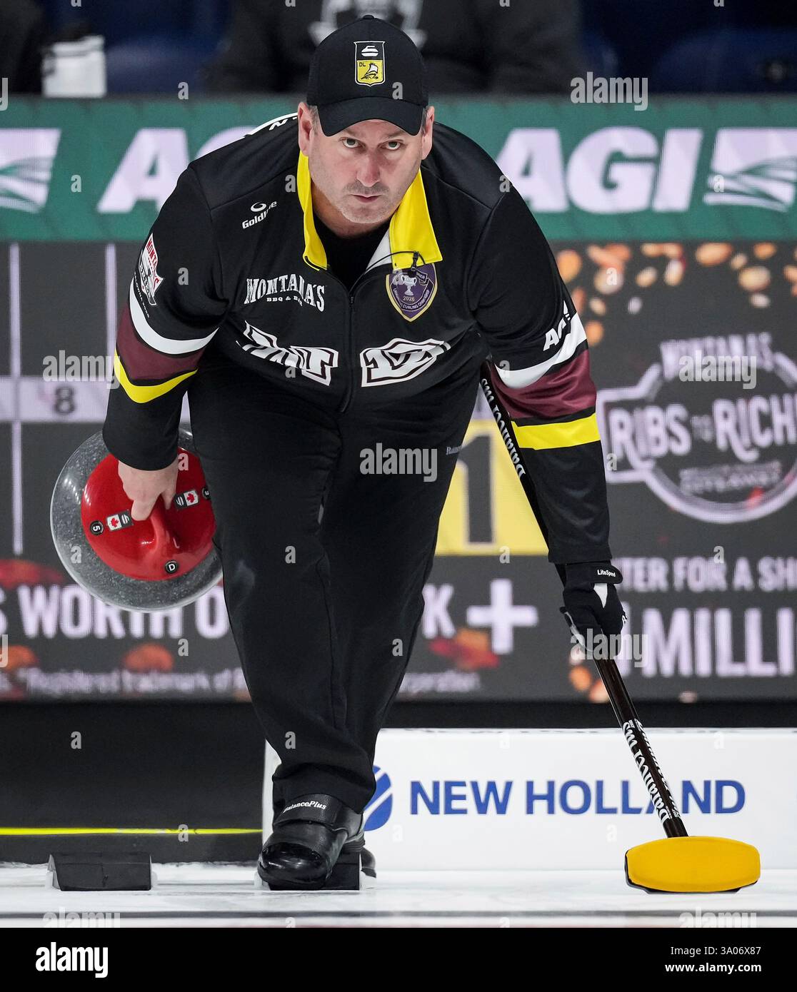 New Brunswick skip James Grattan delivers a rock while playing Nunavut ...