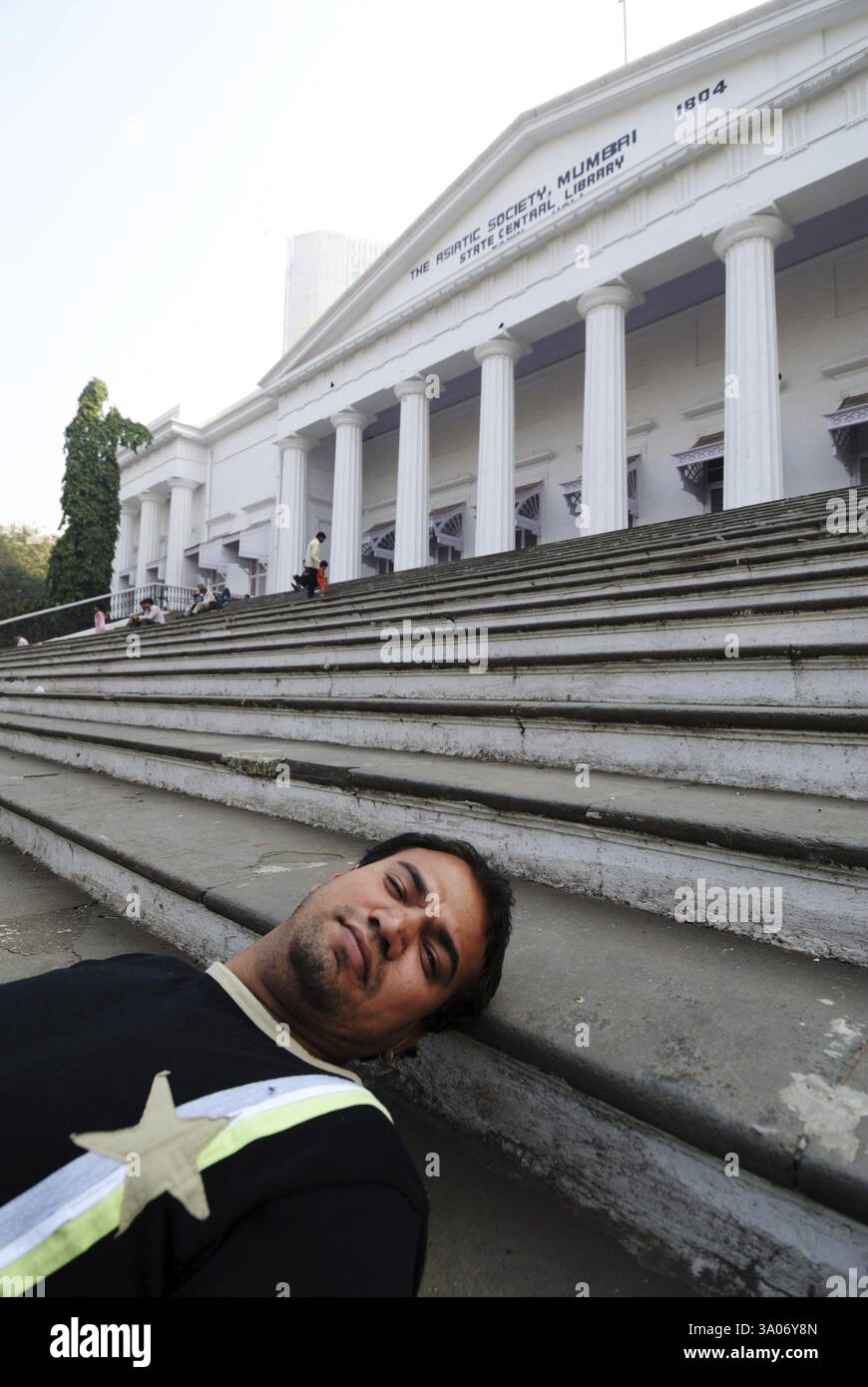 Man on steps of The Asiatic Society State Central Library Town Hall ...