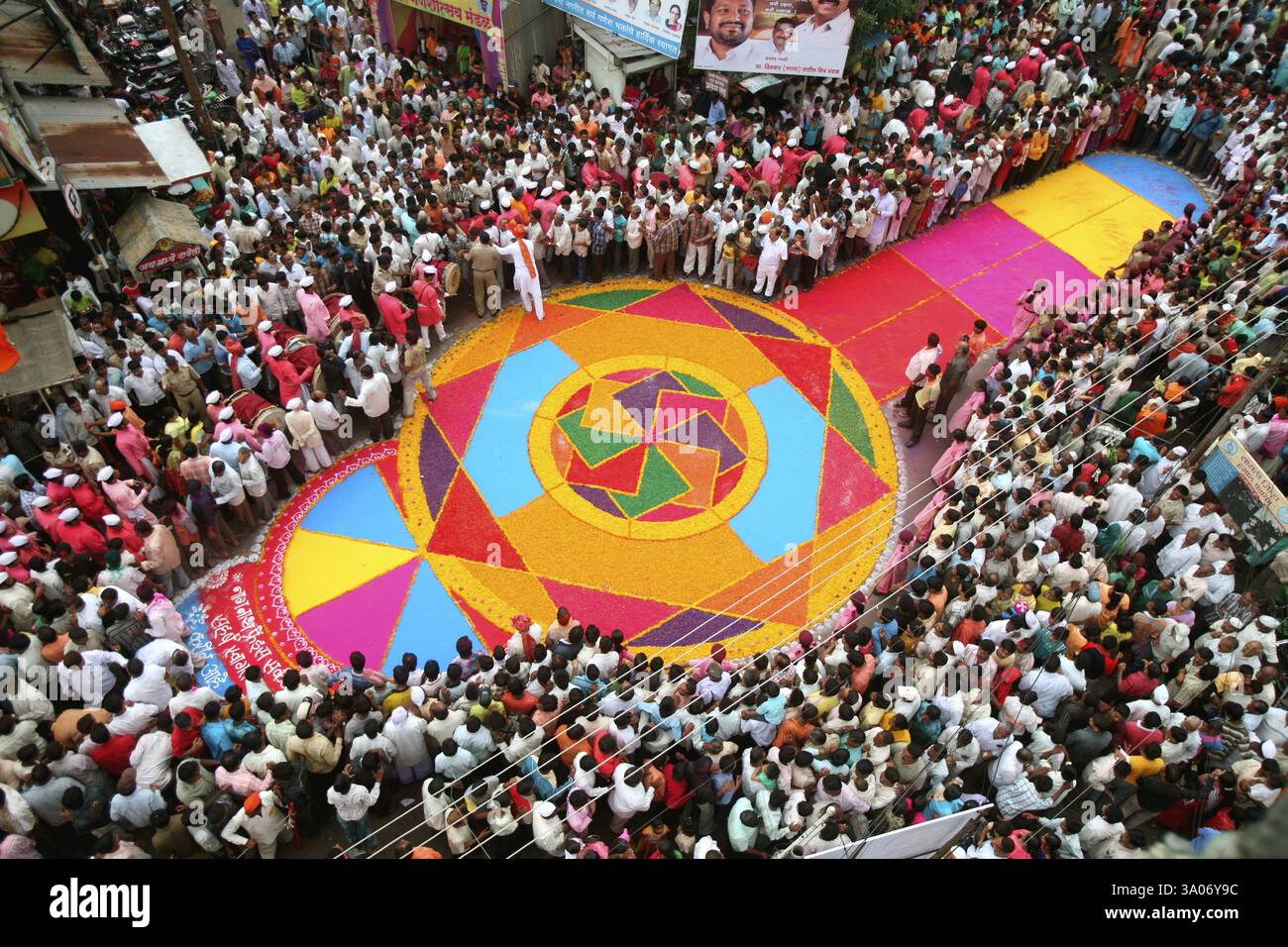 Grand colourful flower Rangoli made on road for immersion celebration ...