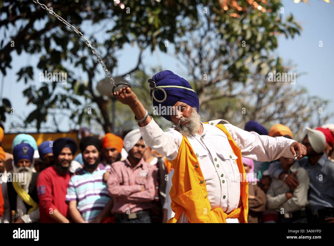 Nihang or Sikh warrior performing stunts with chain in during Hola ...
