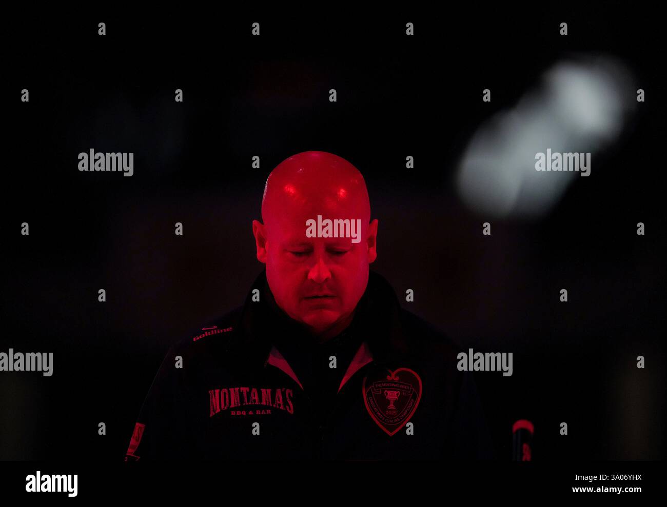 A red spotlight shines on Alberta-Koe skip Kevin Koe before playing ...