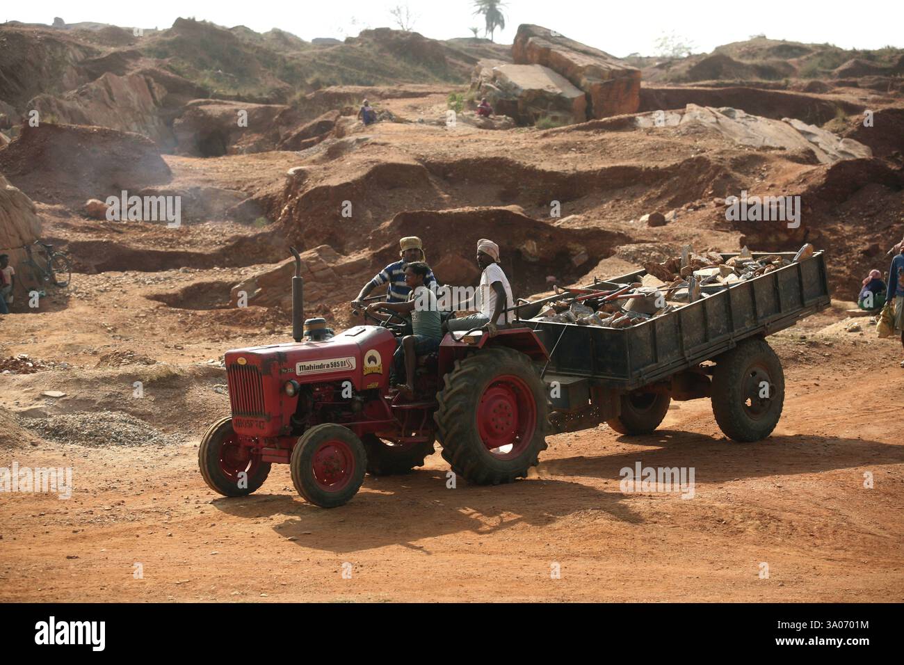 Labourers driving tractor carrying building material in Jharkhand ...