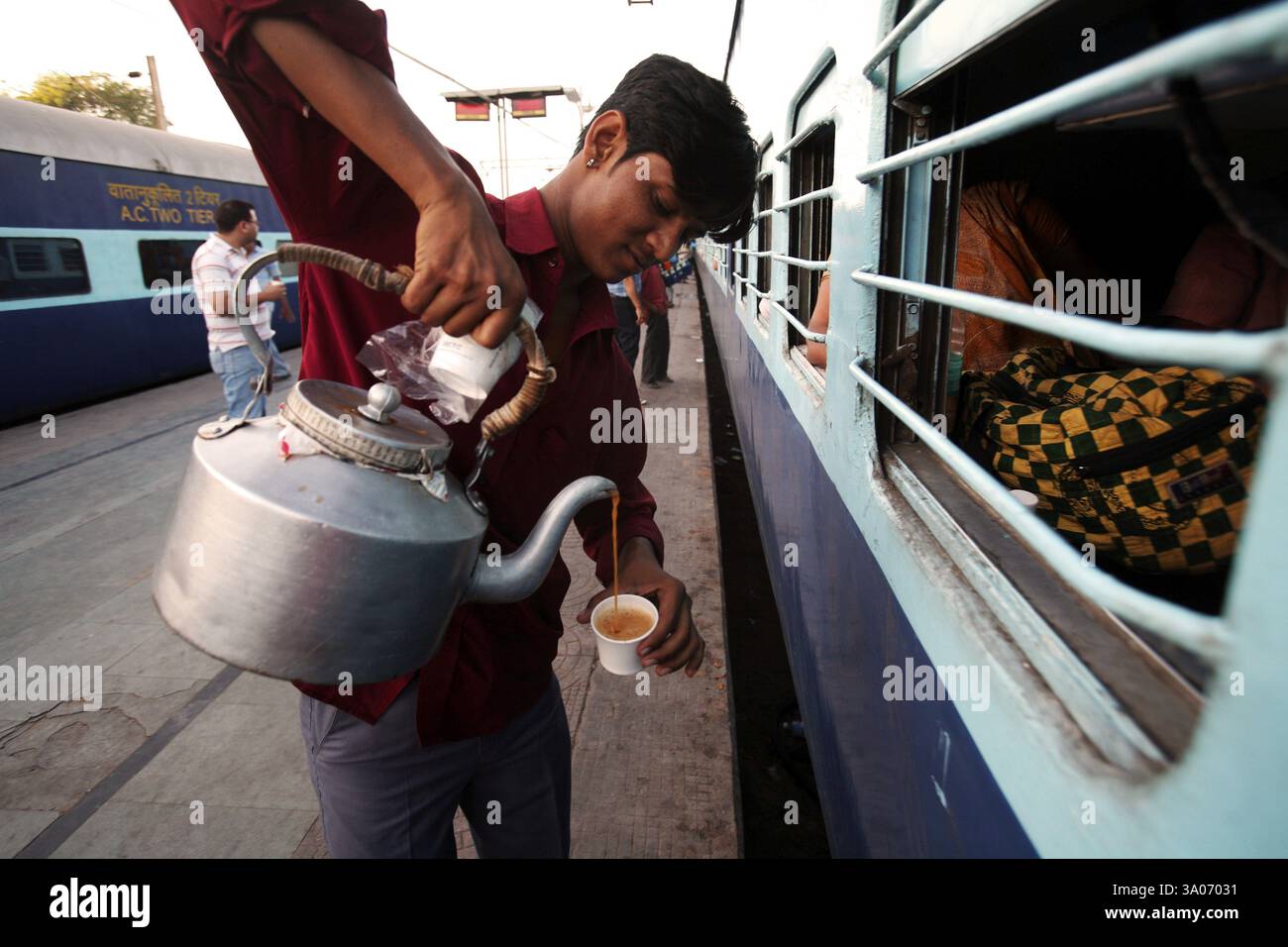Indian railway vendor selling tea to passengers in train at railway ...