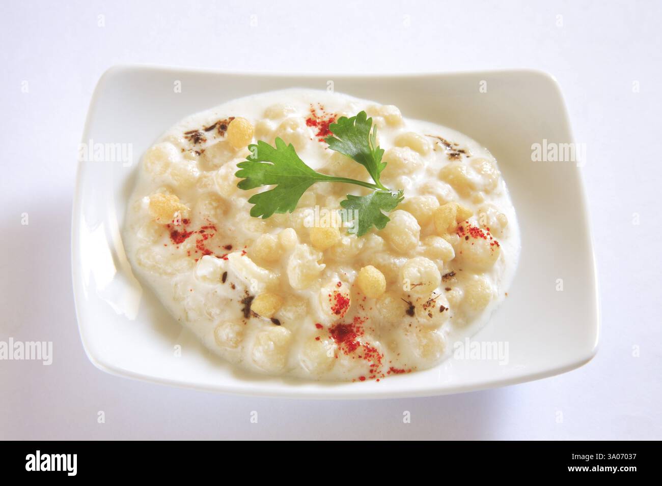 Vegetable salad, boondi raita garnish with coriander leaf in rectangle ...