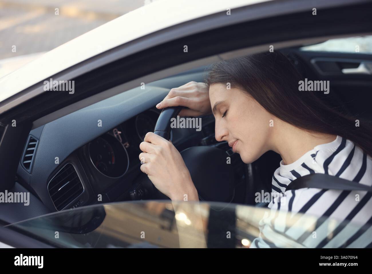 Tired driver sleeping on steering wheel in car, view from outside Stock ...
