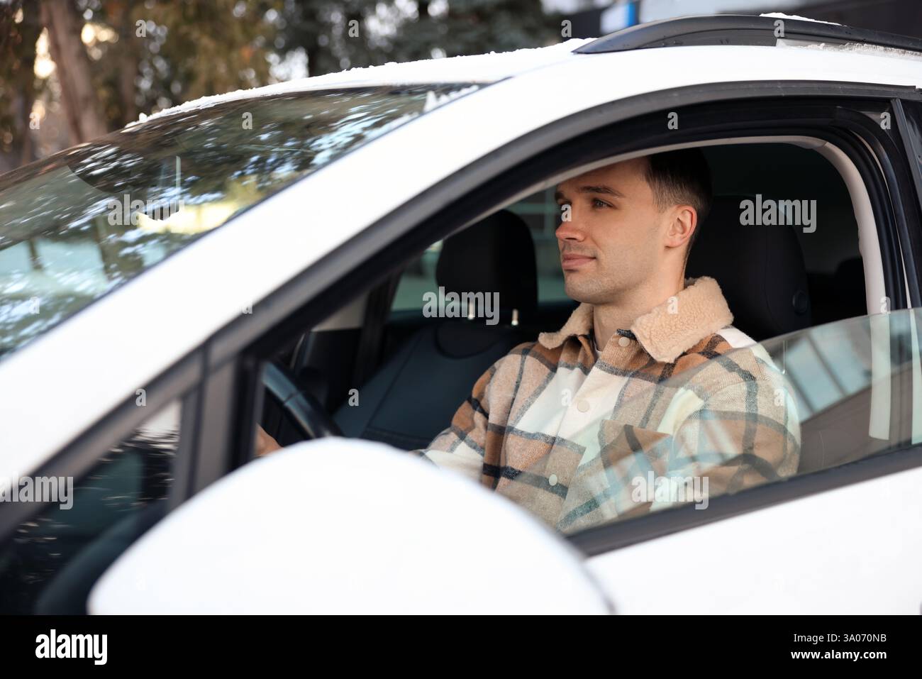 Driver behind steering wheel of modern car, view from outside Stock ...