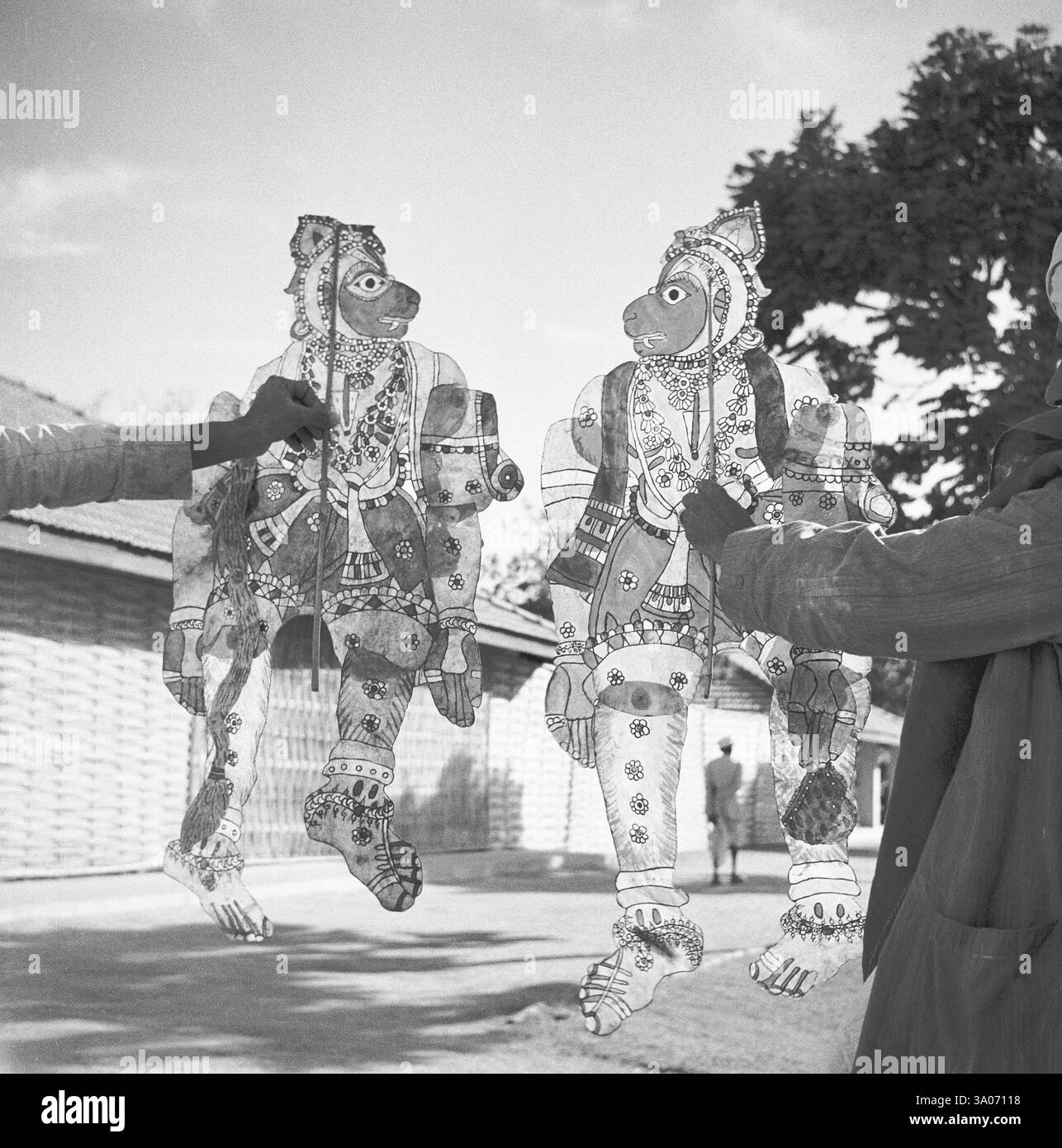 Men displaying transparent painted leather puppets, Shadow puppet plays ...