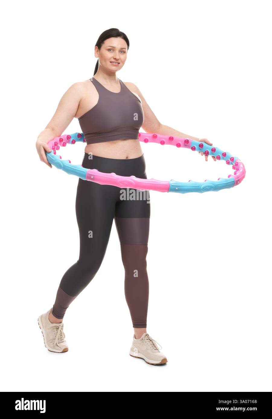 Plus size woman in gym clothes with hula hoop on white background Stock ...