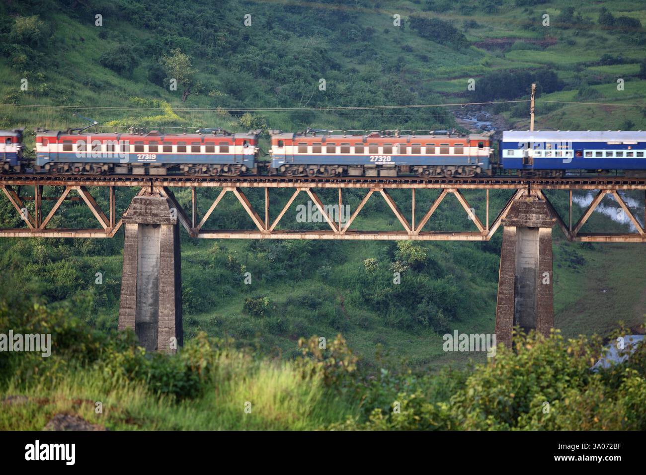 Indian Railways train passing by heightened up bridge at Igatpuri near ...