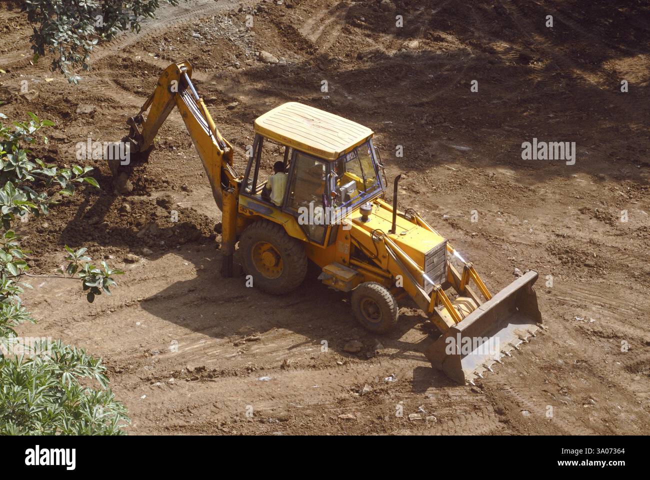 Aerial view of excavator and digger at work known as backhoe loader ...