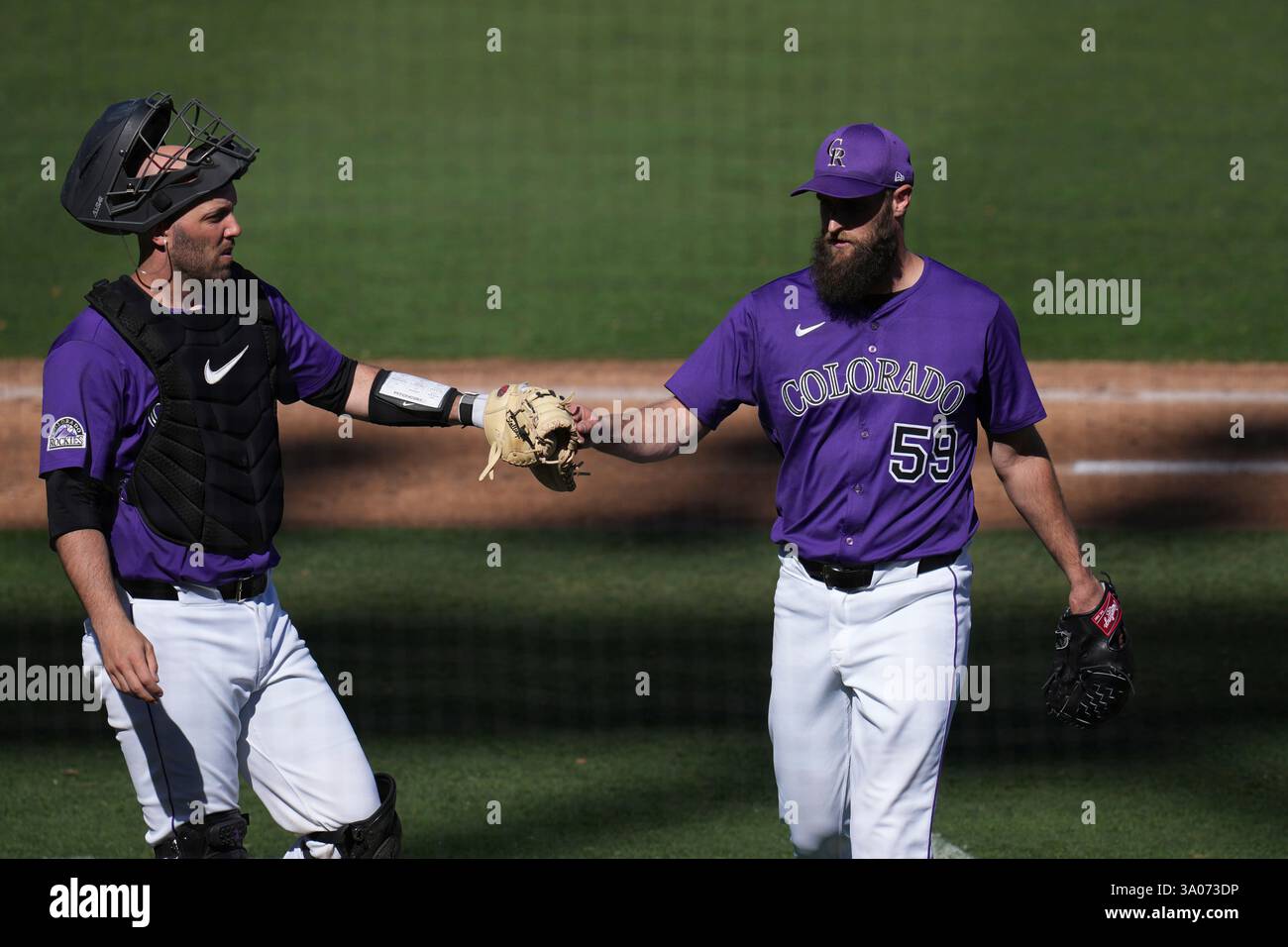 Colorado Rockies pitcher Jake Bird (59) bumps the glove of catcher ...
