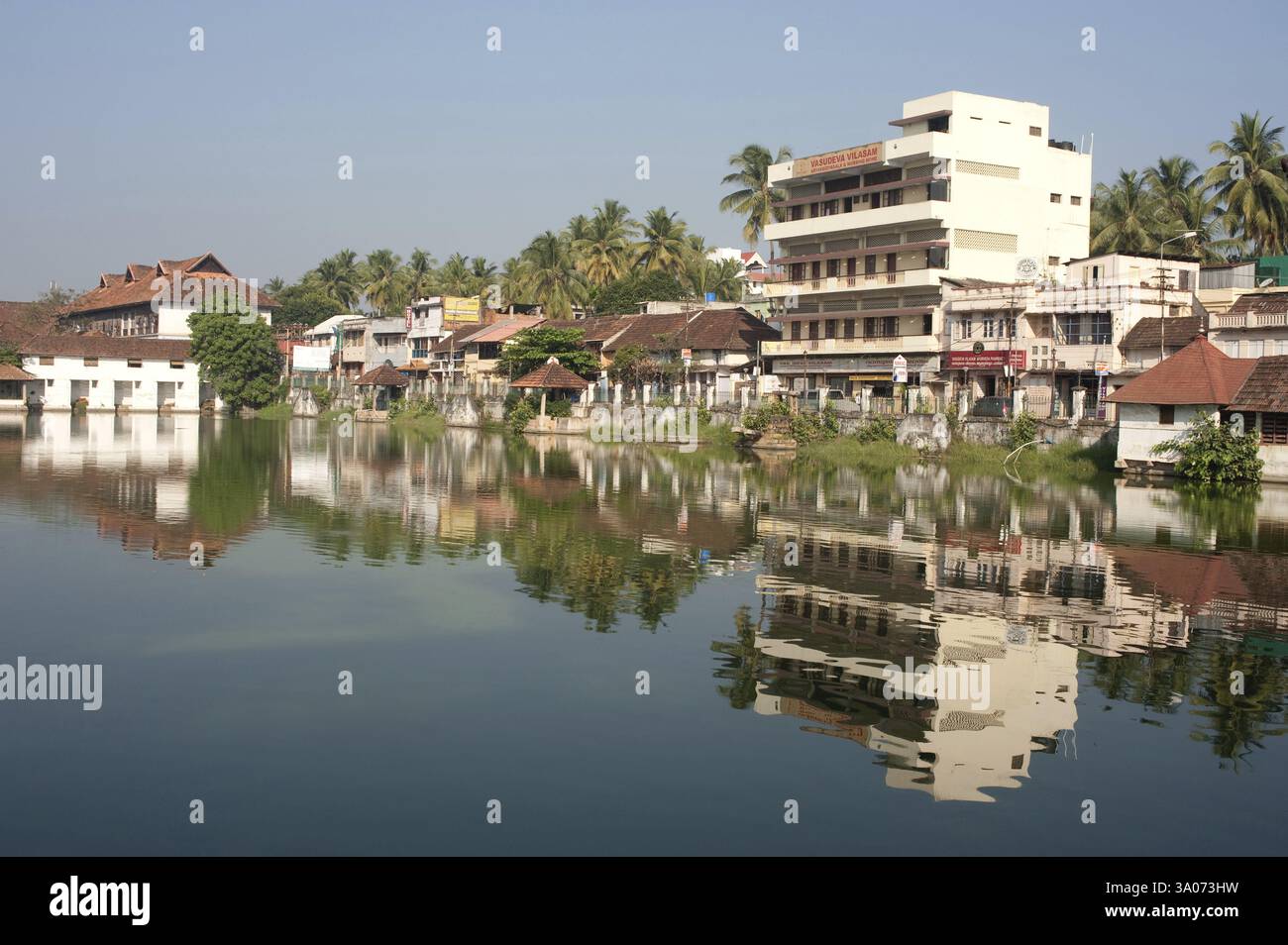 Houses and modern structures reflected in padmatheertham tank at ...