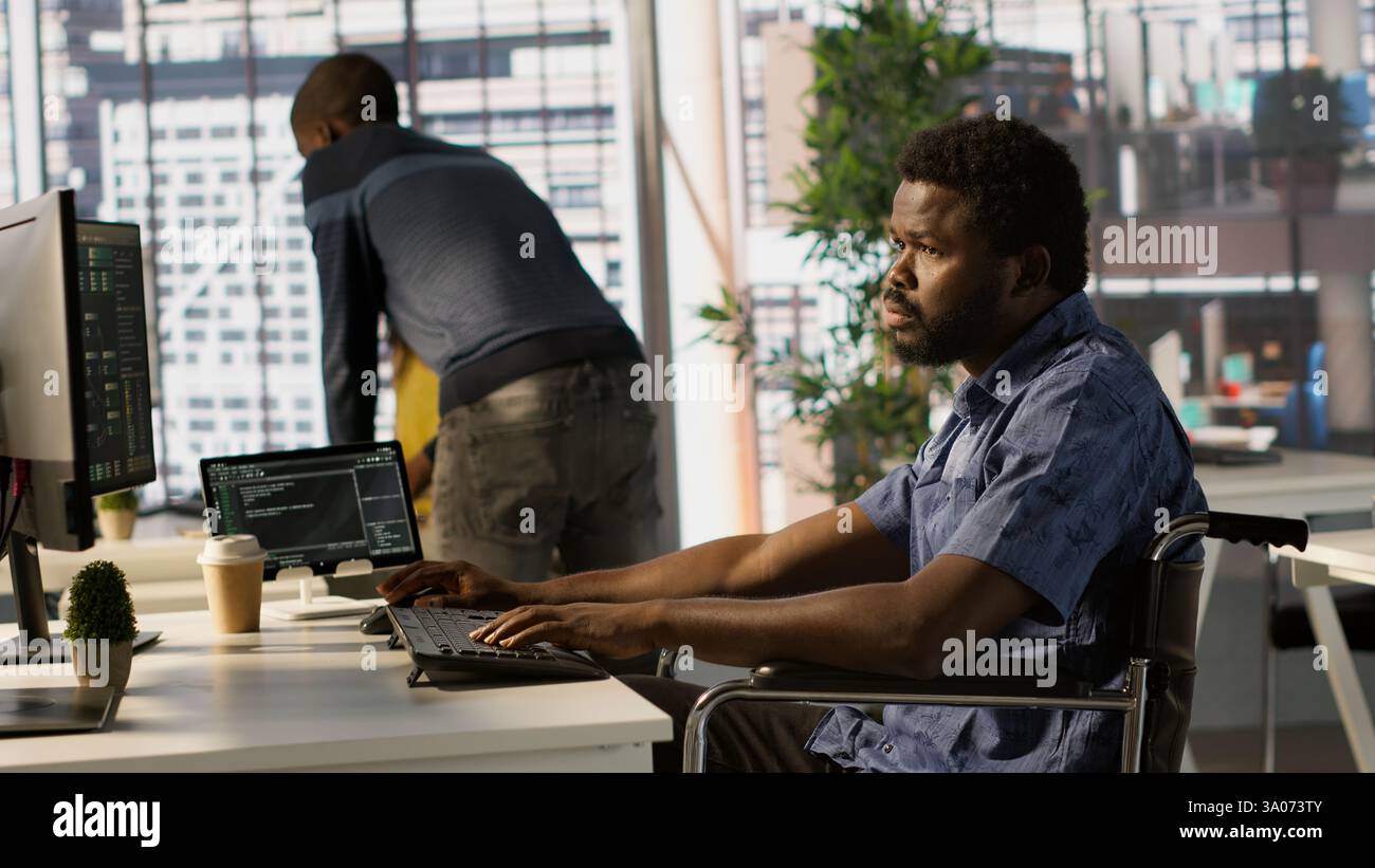 Software technician with disability in inclusive workplace working with ...