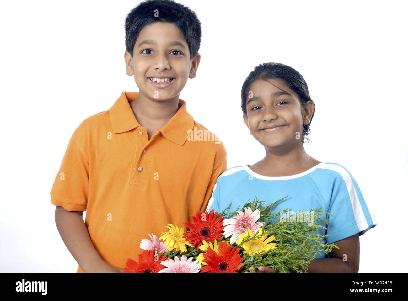 Brother and sister holding flower bouquet and celebrating birthday ...