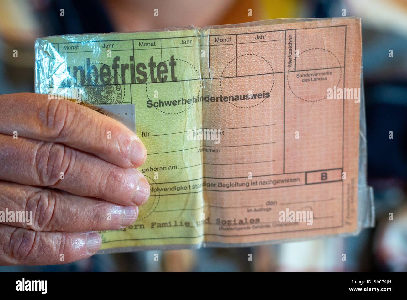Bavaria, Germany - 2 March 2025: A person holds a severely disabled ...