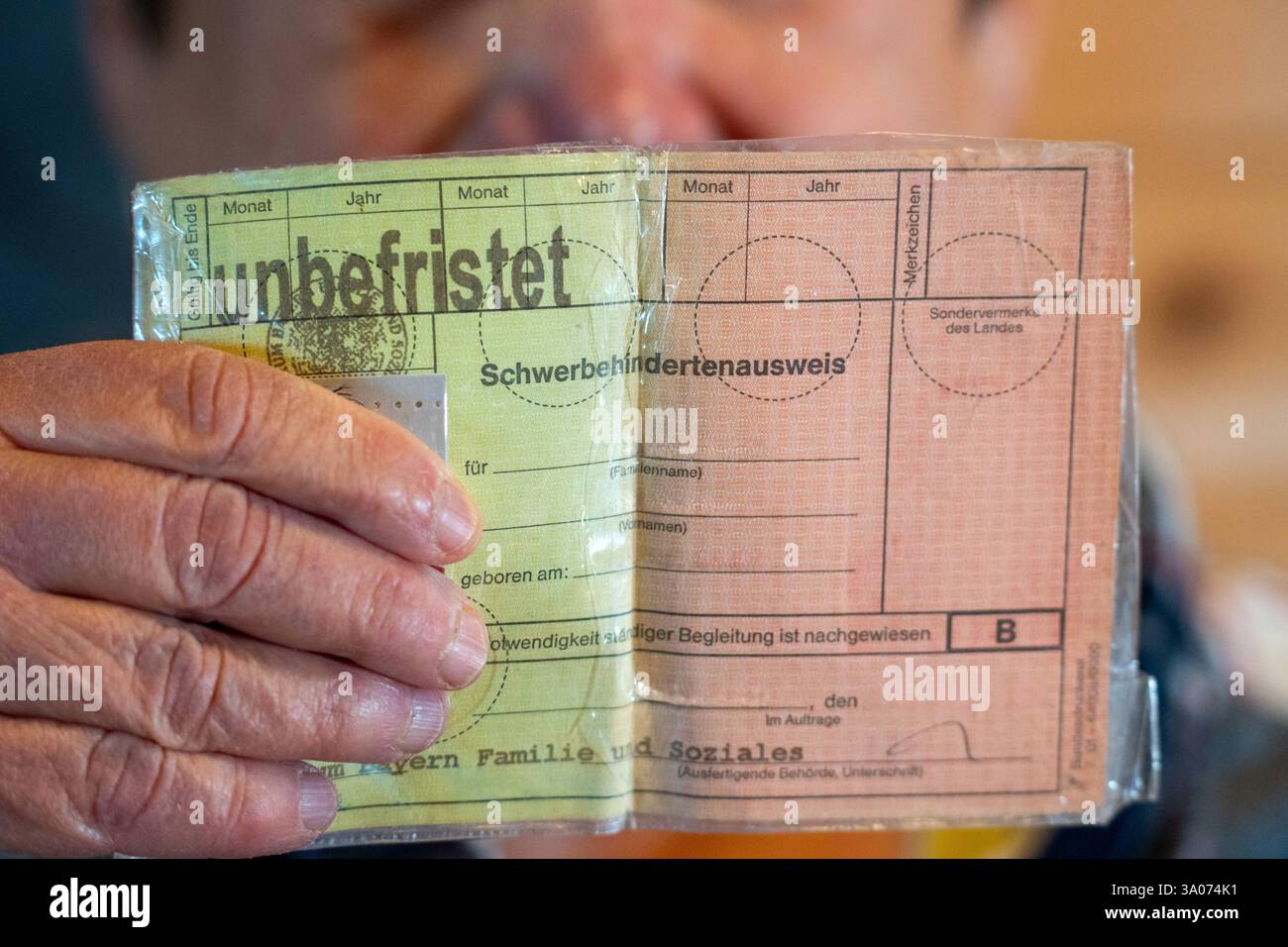 Bavaria, Germany - 2 March 2025: A person holds a severely disabled ...
