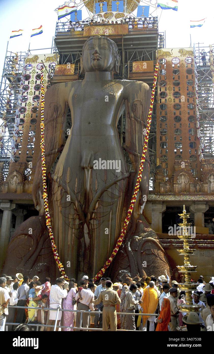 Jain Devotees pouring Vermillion Water on the head of 58.8 feet monolithic Statue of jain saint ...