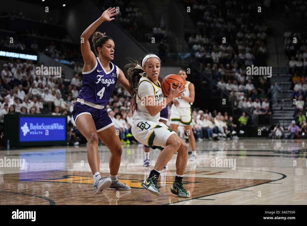 Baylor guard Jada Walker, right, works to the basket against TCU guard ...