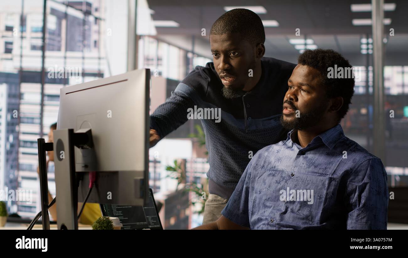 Admin assisted by coworker, working with machine learning artificial ...