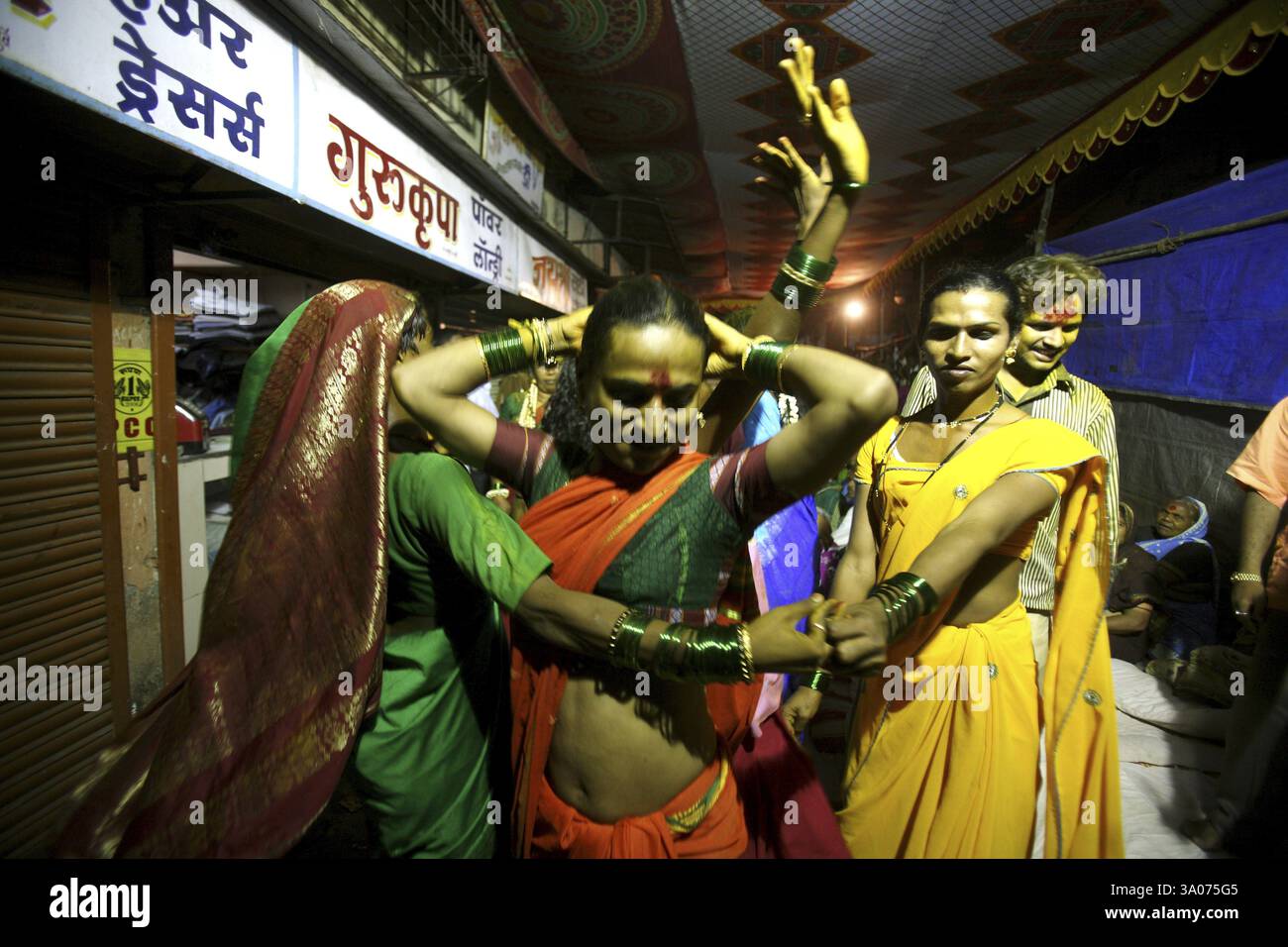 Eunuchs dressed in finery dancing during wedding of eunuchs on occasion ...