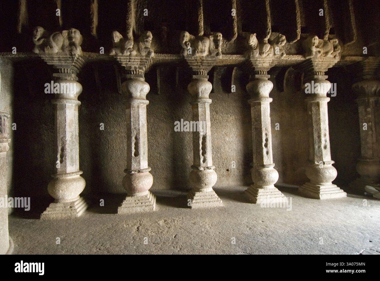 Richly carved pillars in Buddhist caves on mountain at Lenyadri, taluka ...