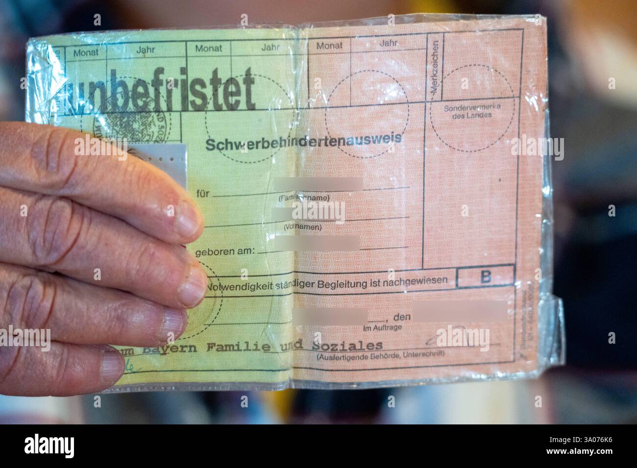 Bavaria, Germany - 2 March 2025: A person holds a severely disabled ...