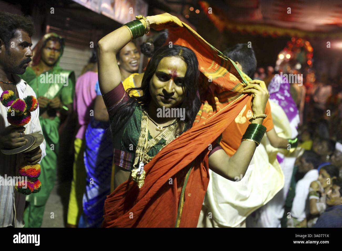 Eunuchs dressed in finery dancing during wedding of eunuchs on occasion ...