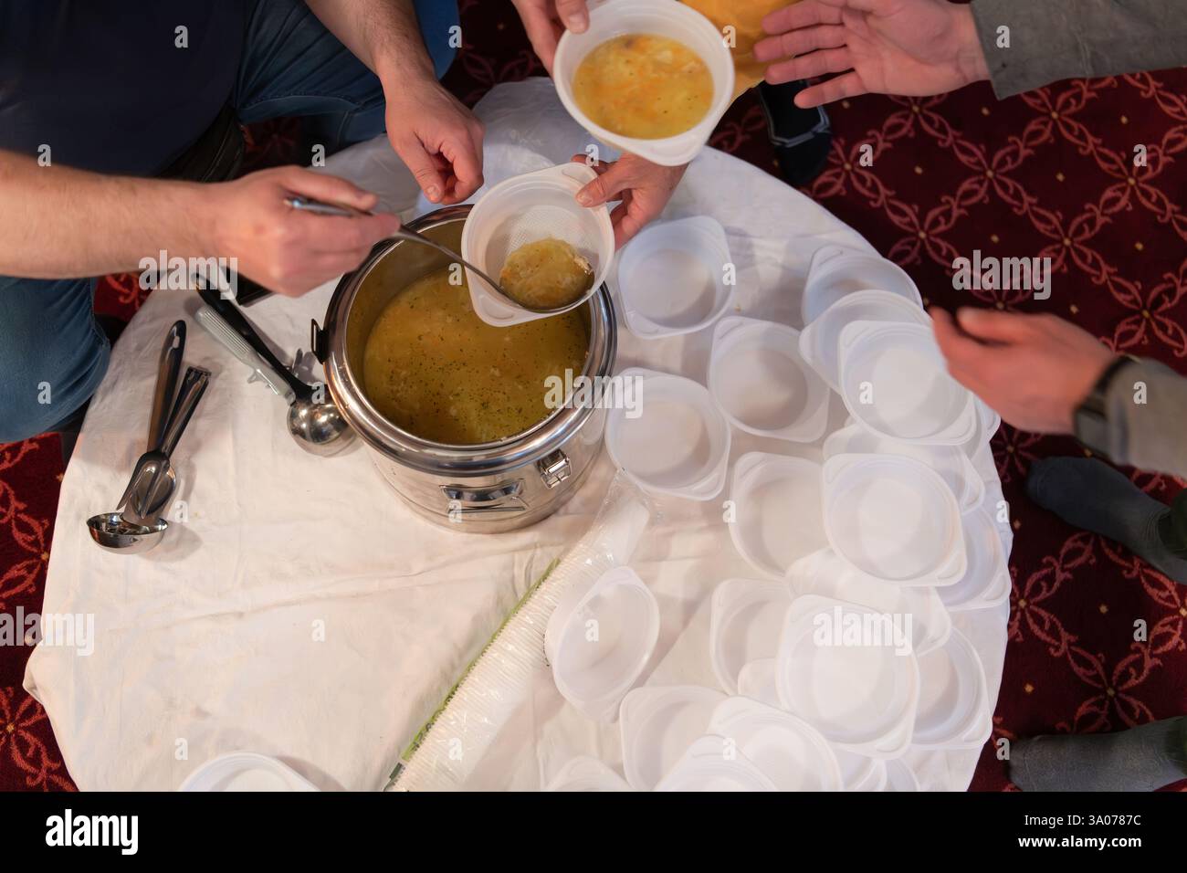 Top view of people serving food at a Mosque a communal meal during ...