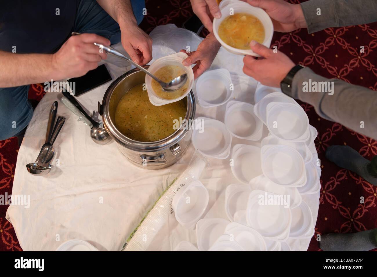 Top view of people serving food at a Mosque a communal meal during ...