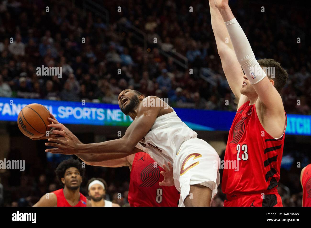 Cleveland Cavaliers' Evan Mobley, center front, grabs a rebound as ...