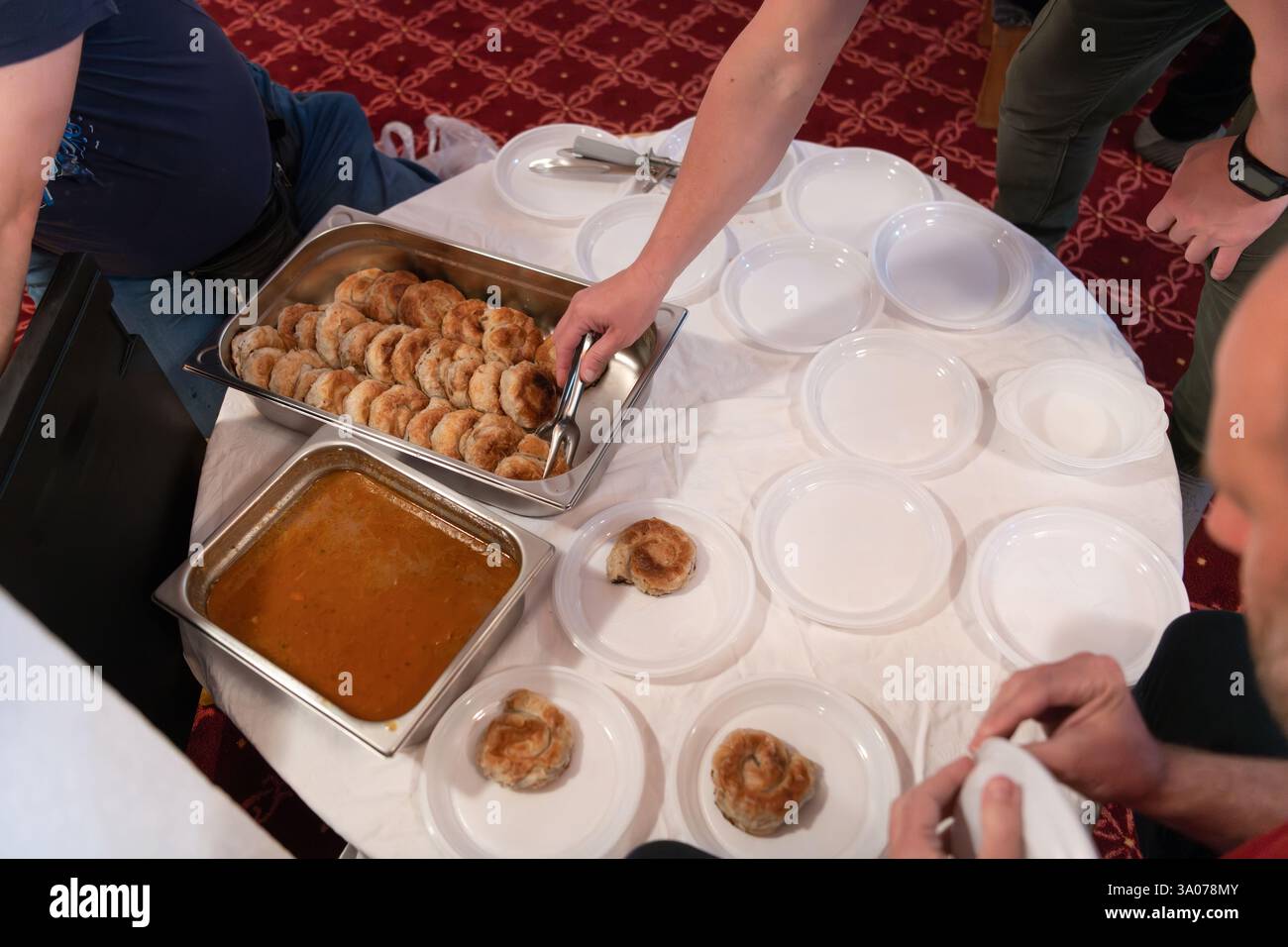 Top view of people serving food at a Mosque a communal meal during ...