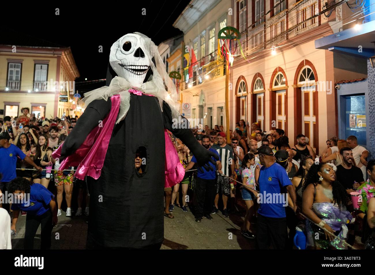 Revelers gather on a street during Carnival in Sao Luiz do Paraitinga ...
