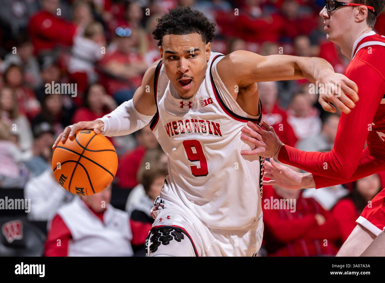 Wisconsin Badgers guard John Tonje (9) handles the ball during an NCAA ...