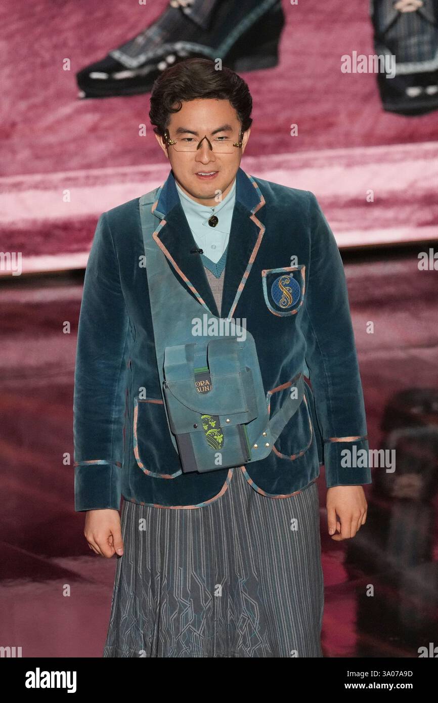 Bowen Yang presents the award for best costume design during the Oscars ...