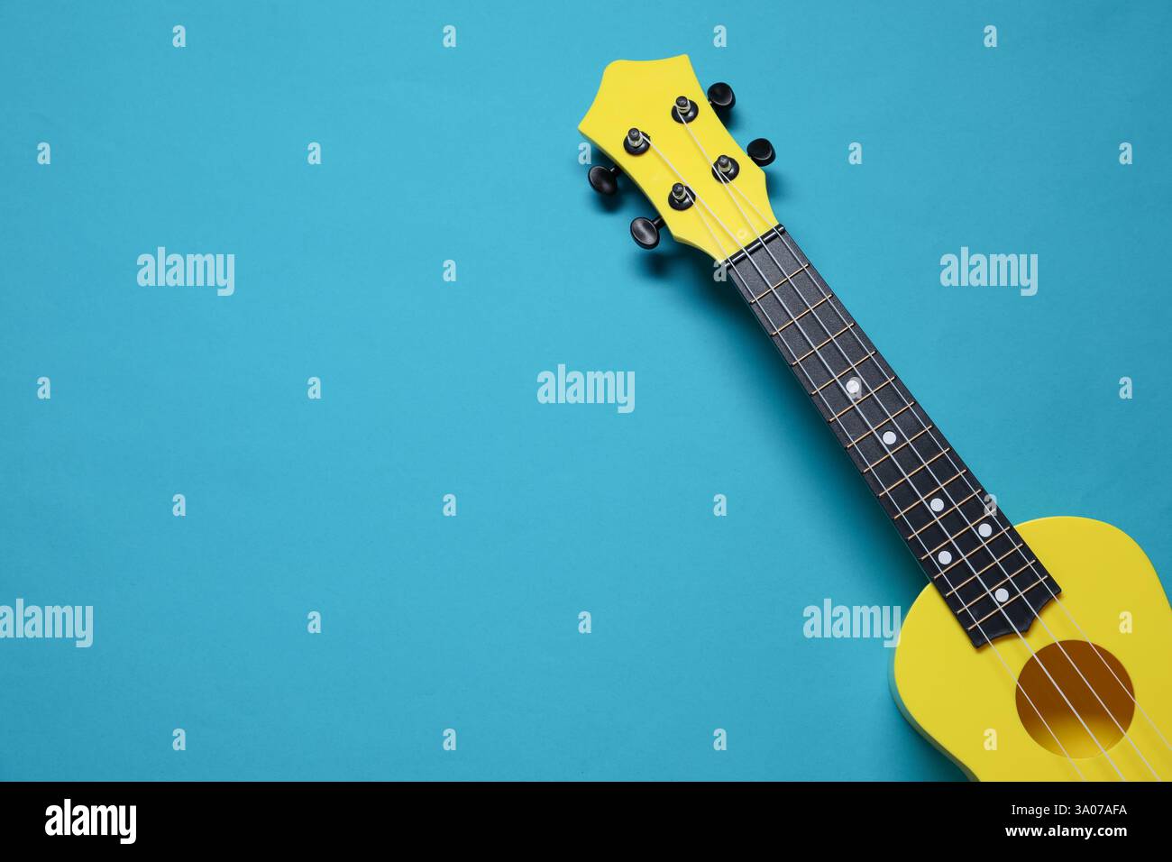 One ukulele on light blue background, top view. Space for text Stock ...