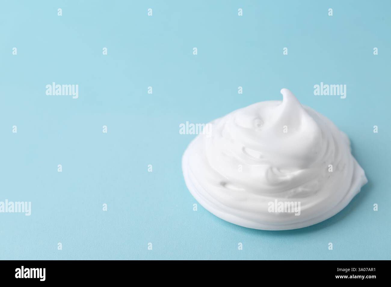 Sample of fluffy foam on light blue background, space for text Stock ...