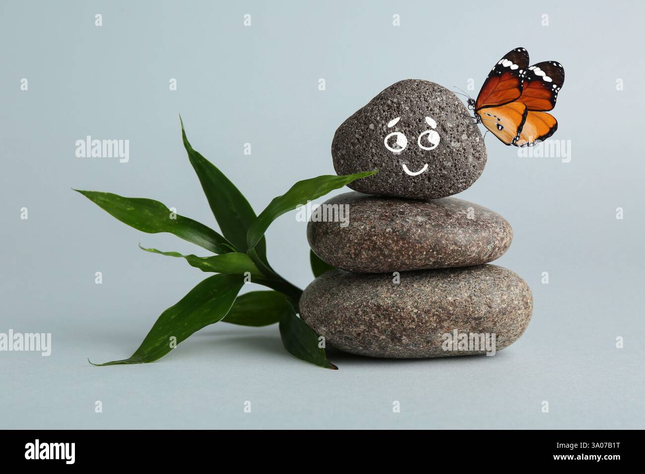 Happy stone glad to see butterfly, harmony. Stacked pebbles and one ...
