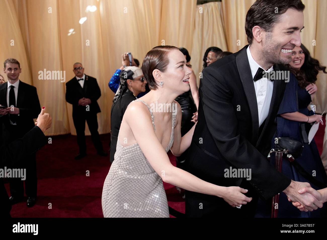 Emma Stone, left, and Dave McCary arrive at the Oscars on Sunday, March ...