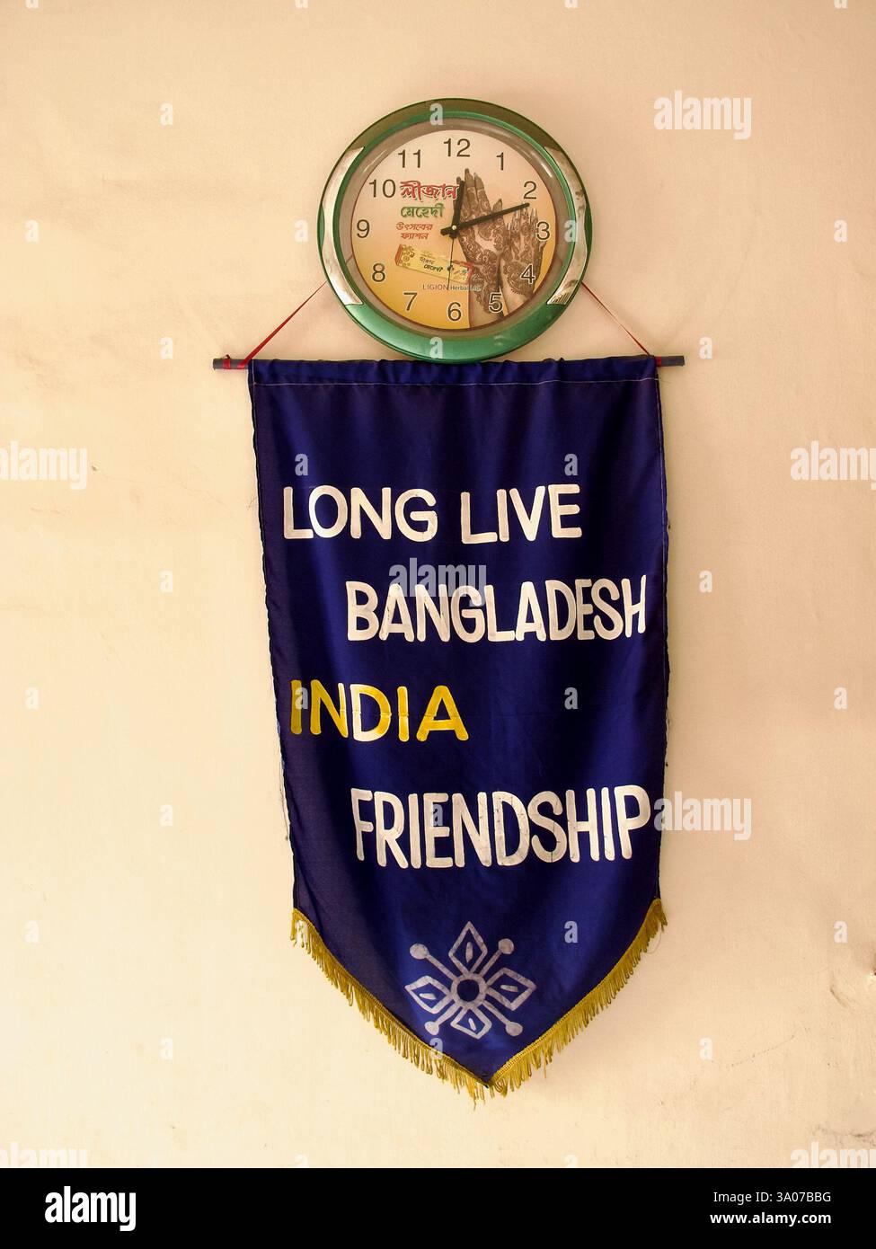 A banner promoting Bangladesh-India friendship hangs beneath a clock in ...