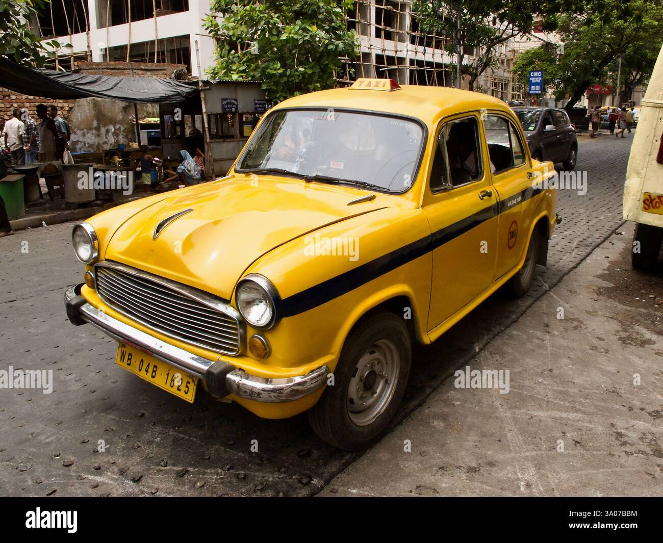 A classic yellow Ambassador taxi, an iconic symbol of Kolkata’s streets ...