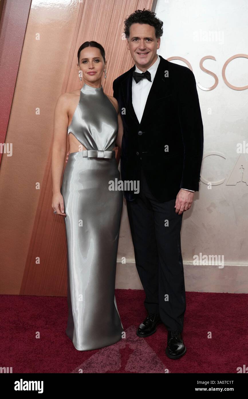 Felicity Jones, left, and Charles Guard arrive at the Oscars on Sunday ...