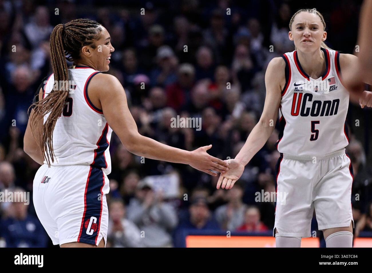 UConn forward Ice Brady (25) slaps hands with UConn guard Paige ...