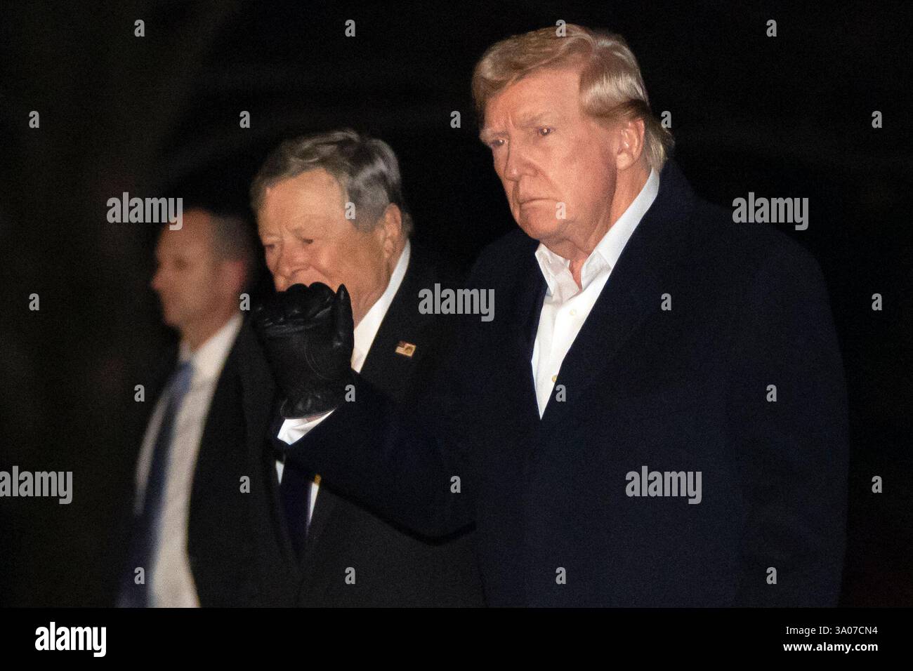 President Donald Trump, accompanied by Viktor Knavs, gestures as he ...