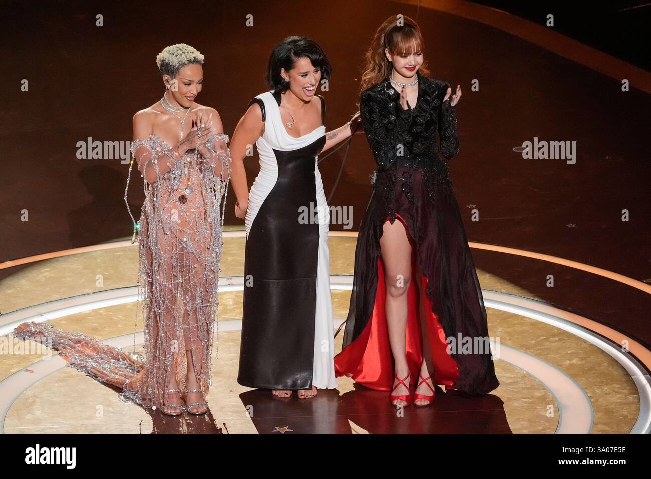 Doja Cat, from left, Raye, and Lisa on stage during the Oscars on ...