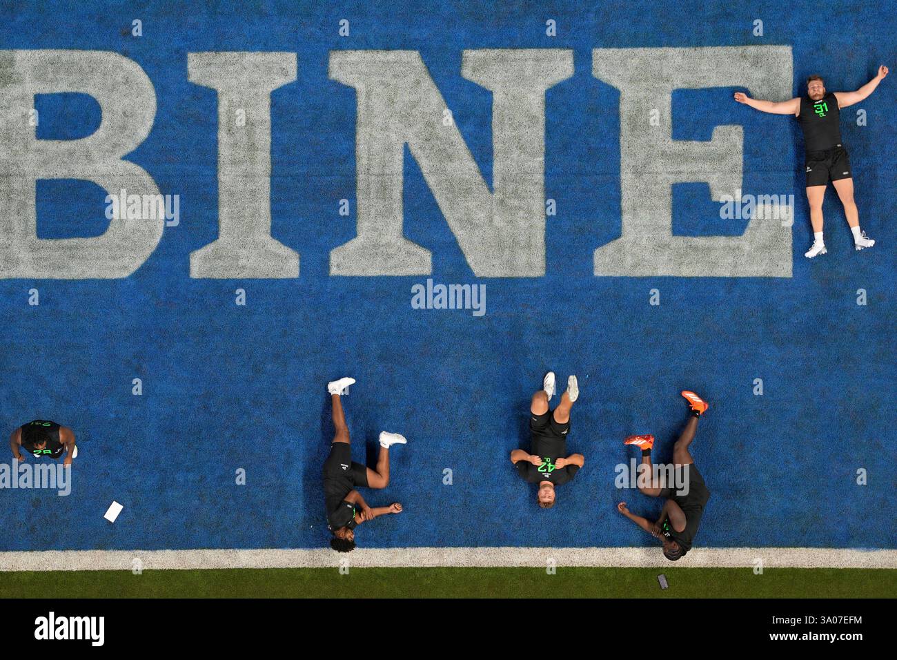 Offensive linemen stretch at the NFL football scouting combine, Sunday ...